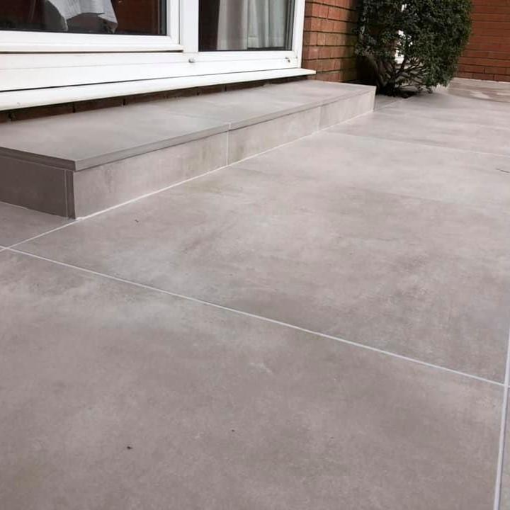 Volcano Beige Porcelain Paving garden patio with greenery.
